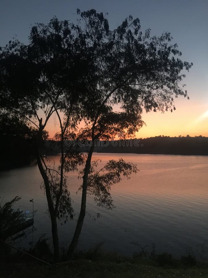 Sunset at the Edge of the Dam Stock Photo - Image of silhouette ...