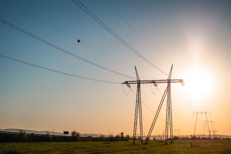 Sunset with Electric Pillars, Grid and Power Generation Stock Photo ...
