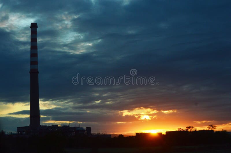 Sunset and factory chimney stock photo. Image of reflection - 351562522
