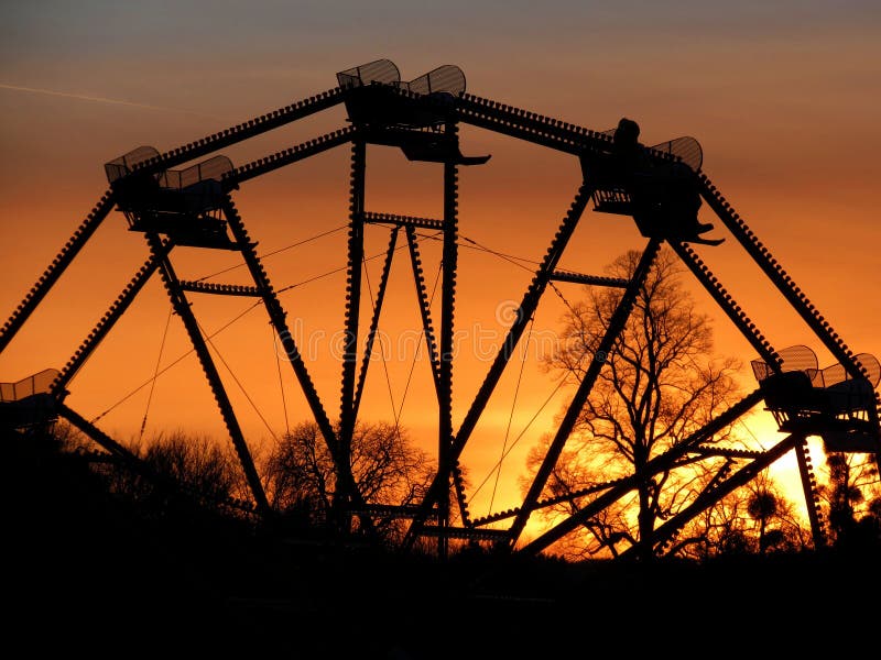 Sunset through the Ferris Wheel Stock Photo - Image of skies ...