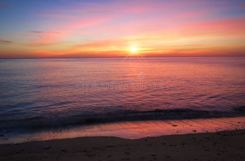 Sunset on a flat sea stock image. Image of horrizon, sunset - 76559749