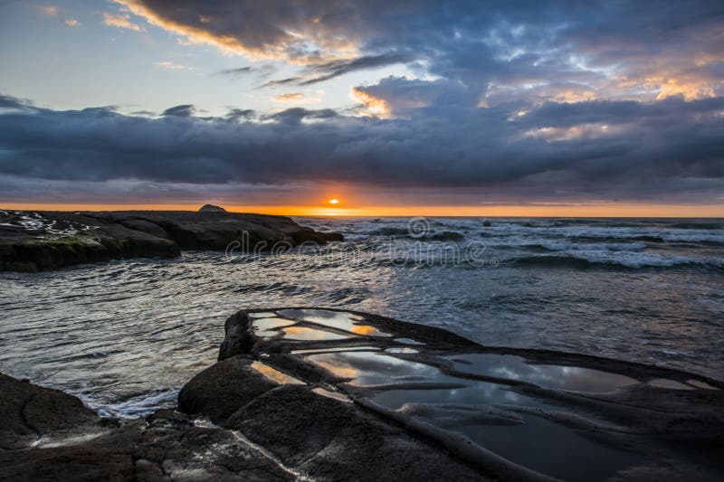Sunset form the rock stock image. Image of zealand, rock - 306200981