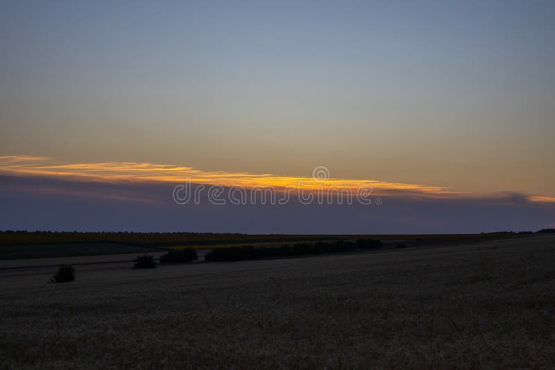 The Sunset Forms a Yellow Line in the Already Dark Sky Stock Image ...