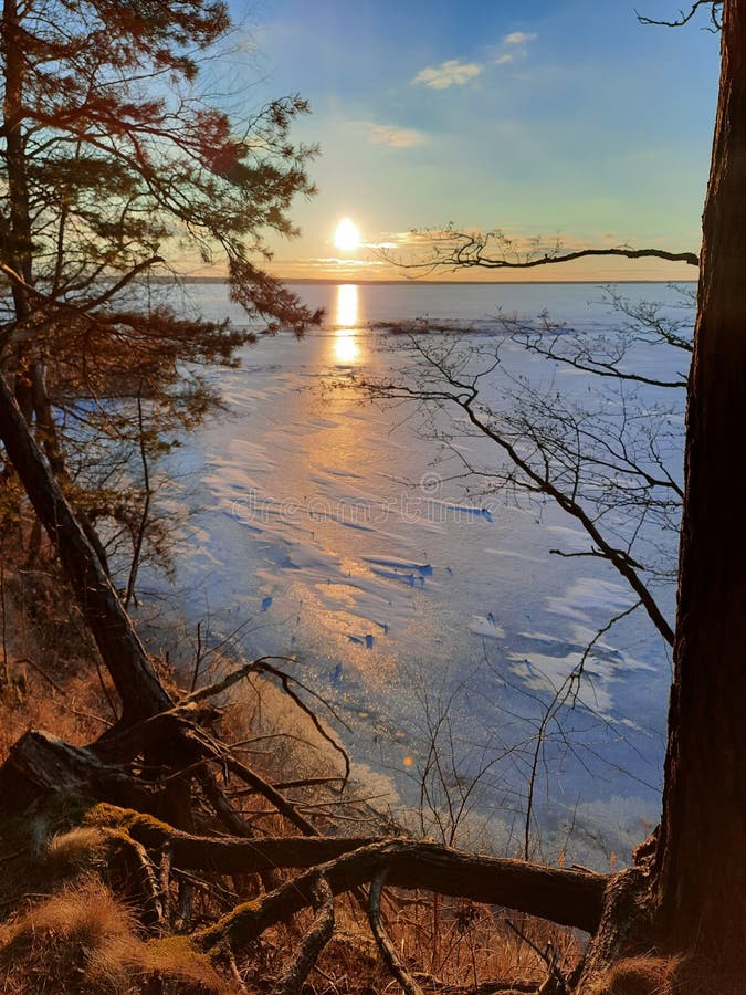 Sunset on a frozen lake. stock image. Image of wilderness - 257619375