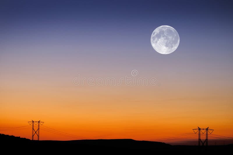Sunset and Full Moon with Power Lines on Horizon Stock Photo - Image of ...
