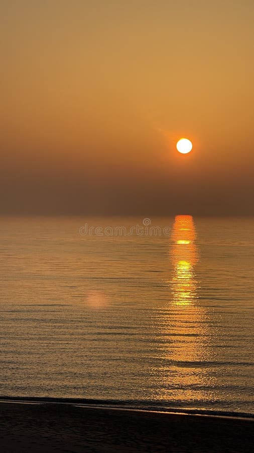 Sunset Glow Reflected on Water Surface with Rich Amber Tones and Soft ...