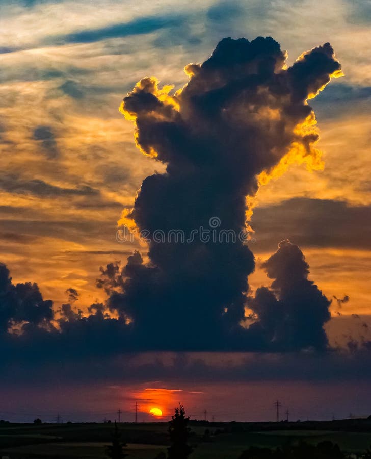 Sunset with Glowing Sky and a Tower of Clouds Stock Photo - Image of ...