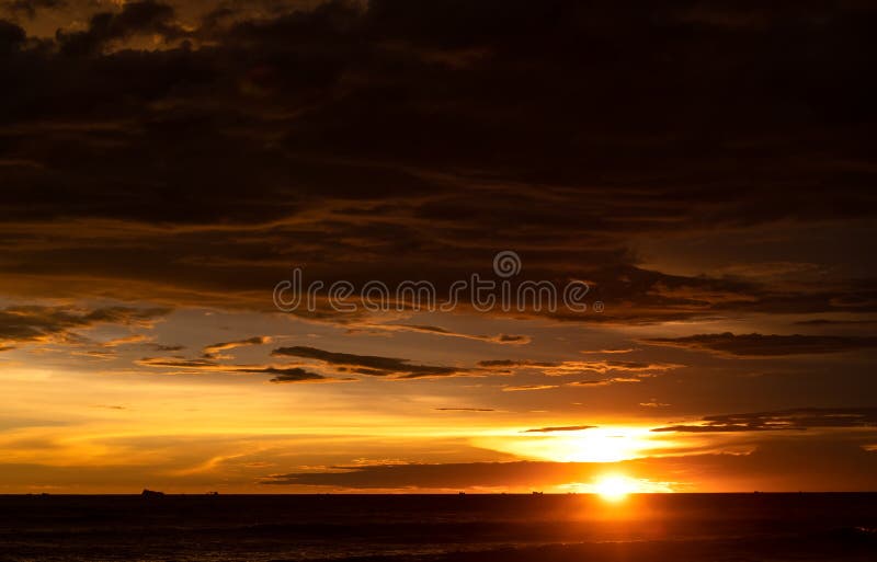 Sunset Golden Hour Over the Sea with Dark Clouds Stock Image - Image of ...