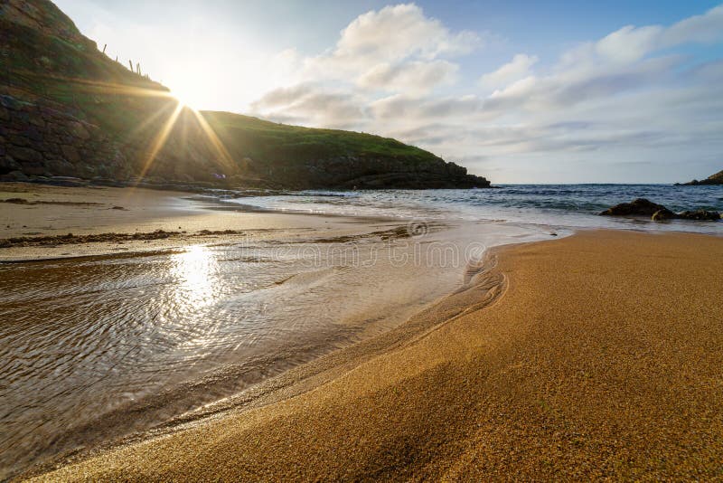 Sunset on the Golden Sand Beach with Small Pools of Water Reflecting ...
