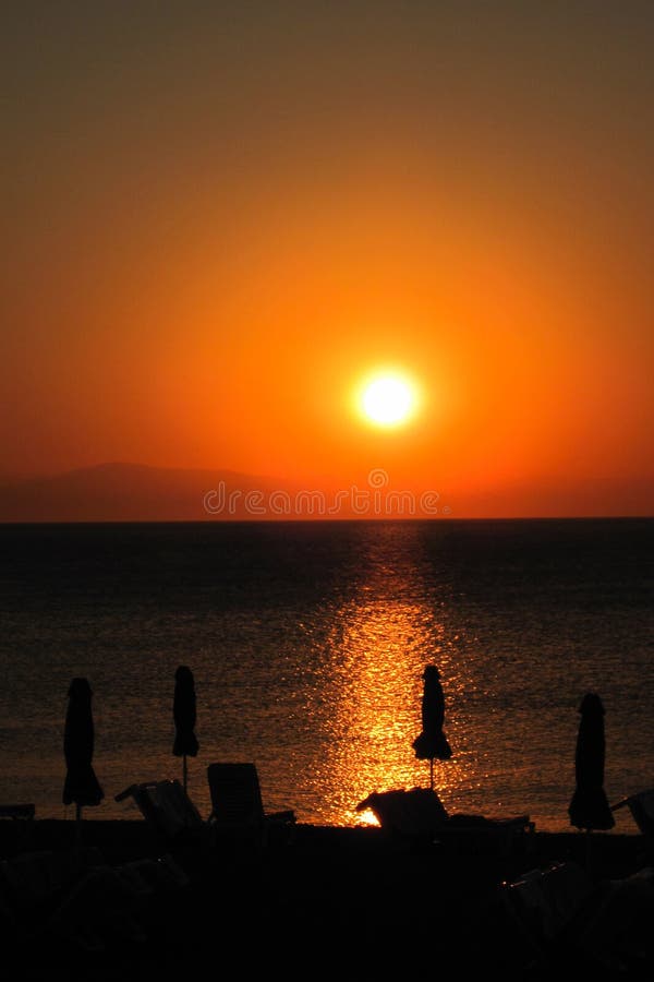 Sunset on the Greece beach stock photo. Image of morning - 30505136