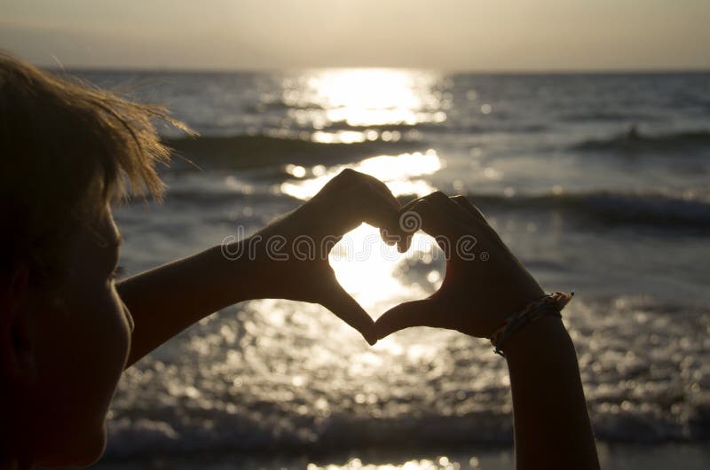 Sunset in heart hands stock photo. Image of recreation - 108940526