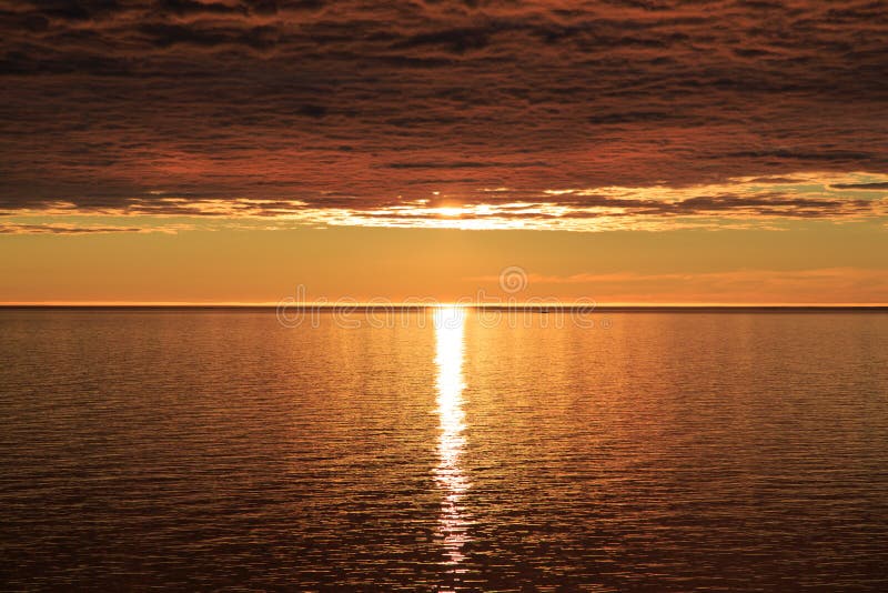 Sunset Hidden by Dense Clouds and Reflected in Water Stock Image ...