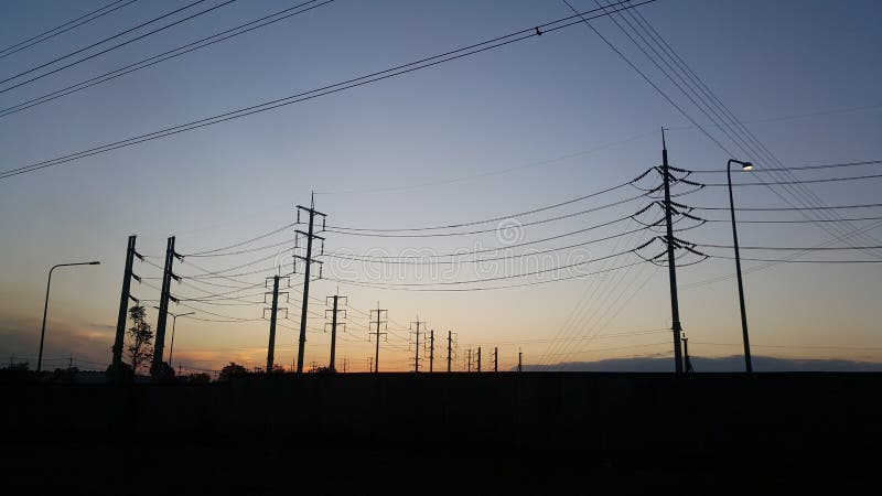 The Sunset and High Voltage Electric Pole Silhouette Stock Photo ...