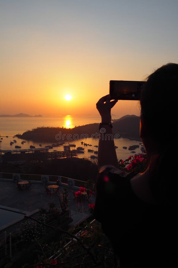 The Sunset Hunter Capturing the Moment by Mobile Phone Stock Image ...