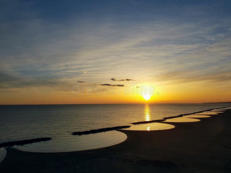 Sunset on italian beach stock image. Image of water - 263008153