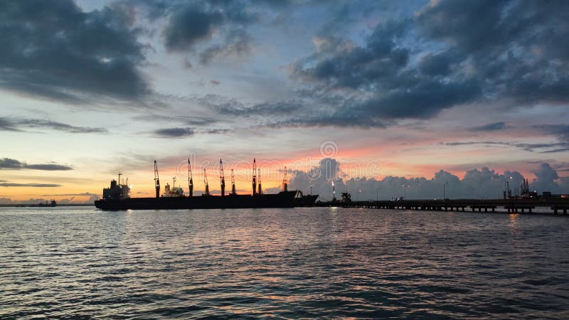 Sunset at jetty with ship stock photo. Image of sunset - 273619434