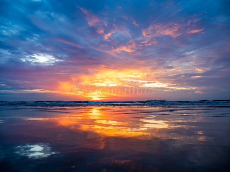 Sunset at Kuta Beach in Bali Stock Photo - Image of landmark ...