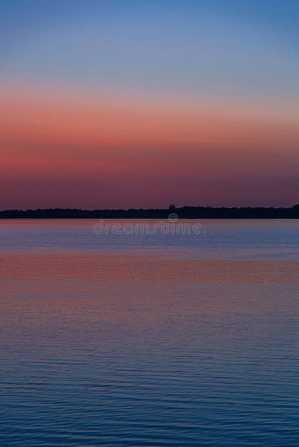 Sunset at the Lagoon. the Sky is Orange and the Lagoon Marks the ...