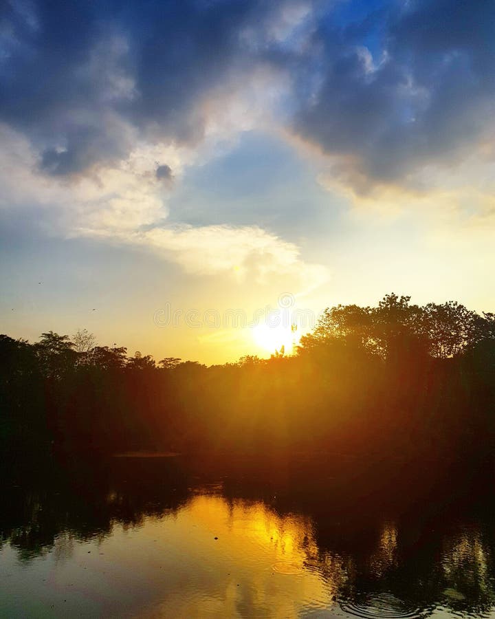 Sunset on the Lake with Overcast Clouds Stock Photo - Image of sunrise ...