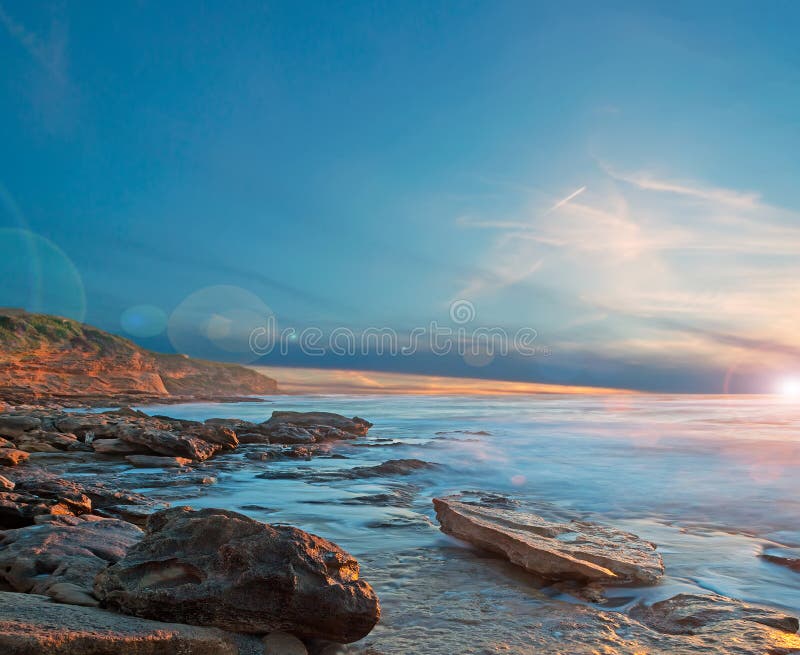 Sunset and Lens Flare by the Shore Stock Photo - Image of colorful ...