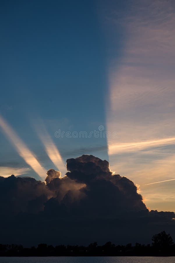 Sunset with Light Streaks and Half of Sky Lit by Setting Sun Stock ...