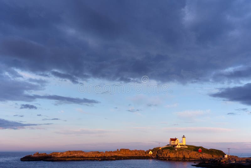 Sunset by Lighthouse As Storm Approaches Stock Image - Image of nubble ...