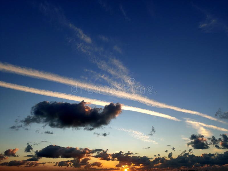 Sunset with Line of Heavy Grey Clouds and Two Lines with a Cloud into ...