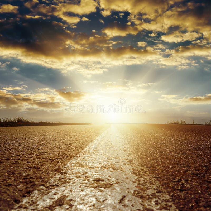 Sunset in Low Clouds Over Asphalt Road with White Line Stock Photo ...