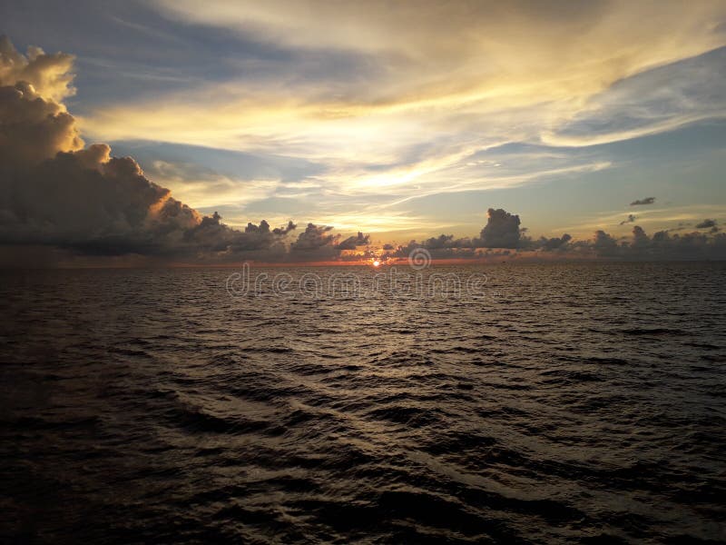Sunset at Middle Ocean with Yellow Sky and Black Cloud. Stock Photo ...