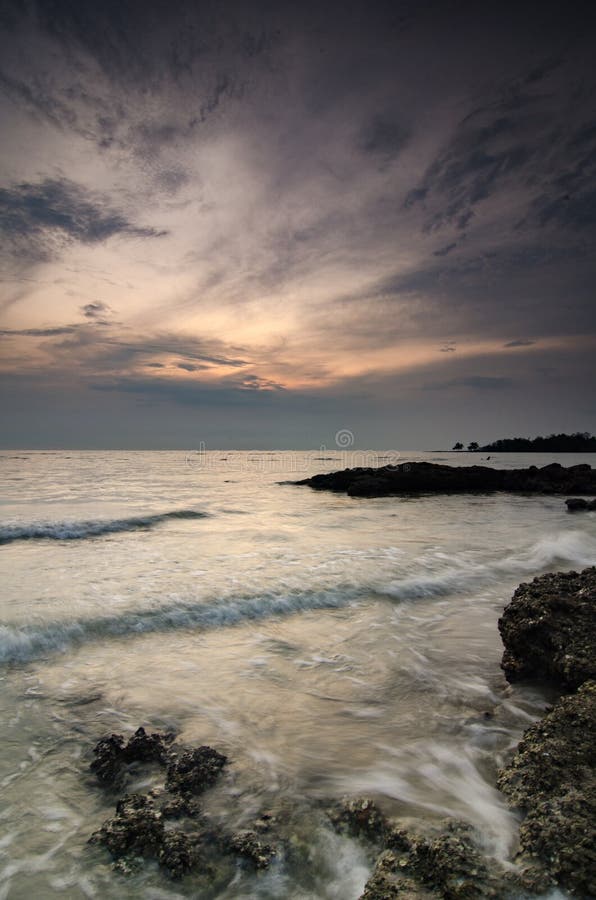 Sunset Moment at the Beach with Soft Wave Hitting the Rock and Cloudy ...