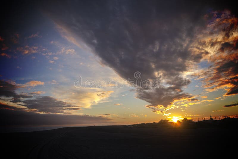 Sunset in Moody Sky stock photo. Image of beach, vignette - 116757460