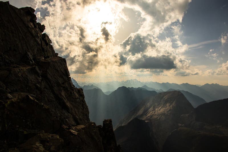 Sunset between Mountains and Clouds Stock Image - Image of rocks ...