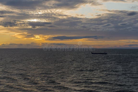 Sunset from the North Sea and a Merchant Ship Stock Image - Image of ...