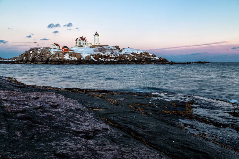 Sunset on Nubble Lighthouse, Maine Stock Photo - Image of cold ...