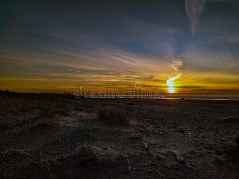 Sunset NW beach in January stock photo. Image of landscape - 138472316