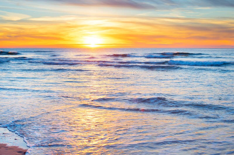 Sunshine on Empty Ocean with Cloud Layer and Colorful Sky Stock Photo ...