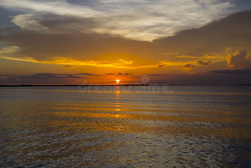 Sunset at the ocean stock photo. Image of orange, resort - 77092052