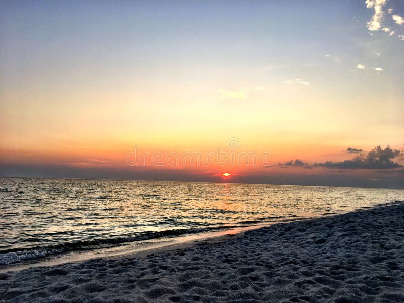 Orange Sun Dipping into the Ocean Stock Photo - Image of coast ...