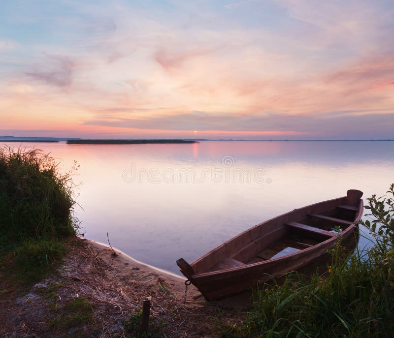 Sunset with Old Flooding Boat on Summer Lake Shore Stock Photo - Image ...