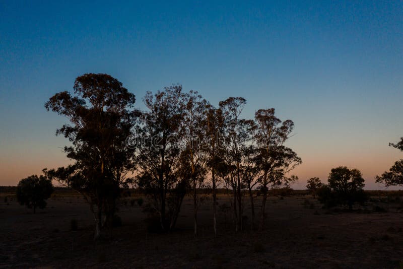 Sunset in the outback stock image. Image of sunset, silhouette - 257802635