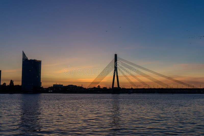 Riga at sunset, Latvia stock photo. Image of bridge - 157133688