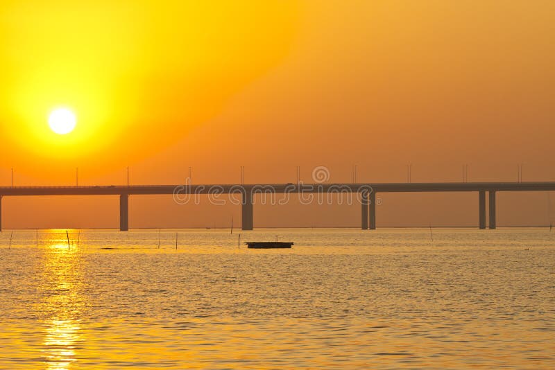Sunset Over a Bridge with Moving Boats Stock Photo - Image of night ...
