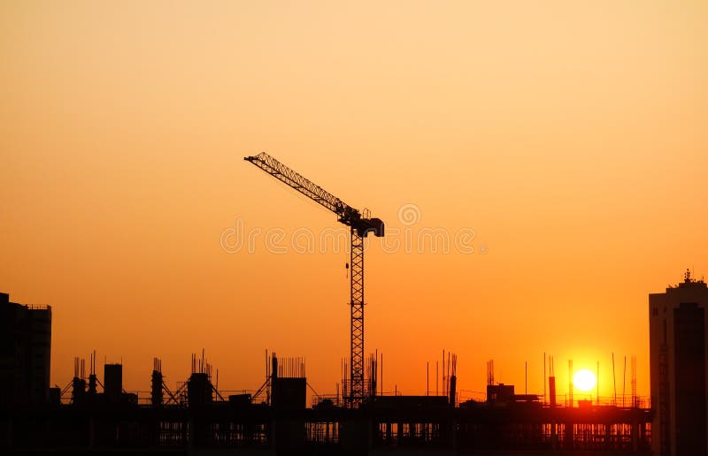 Sunset Over Building Construction in the City. Crane and Structure ...