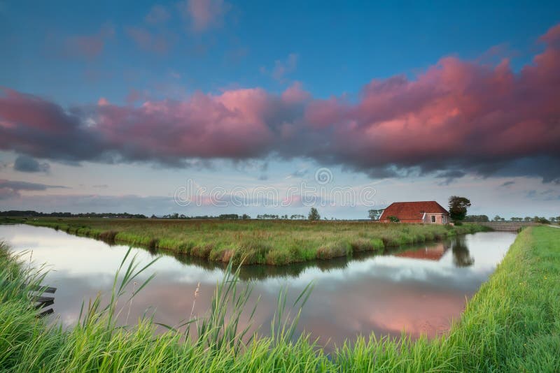 Sunset Over Charming Dutch House by River Stock Image - Image of grass ...