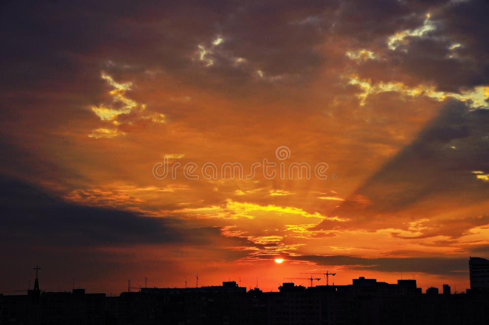 Sunset over city stock image. Image of clouds, cranes - 13385653