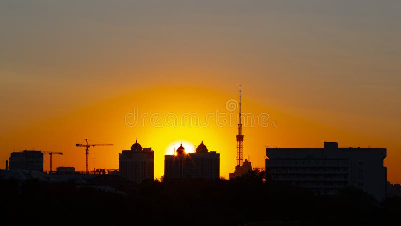 The Sunset Over the City is a Bright Orange Sky, and Lustrous Clouds ...
