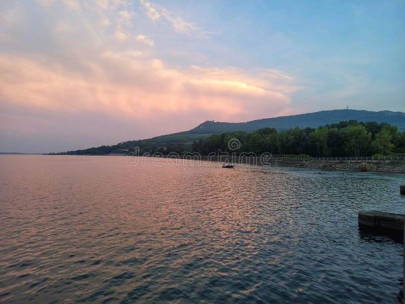 Sunset over the dam stock photo. Image of ocean, dusk - 258064748
