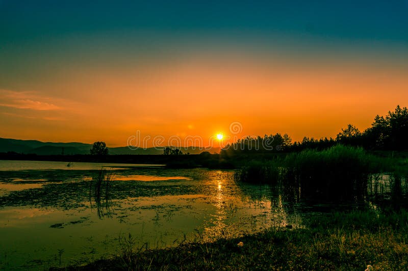 Sunset over a dam stock photo. Image of shadows, silhouettes - 158875930