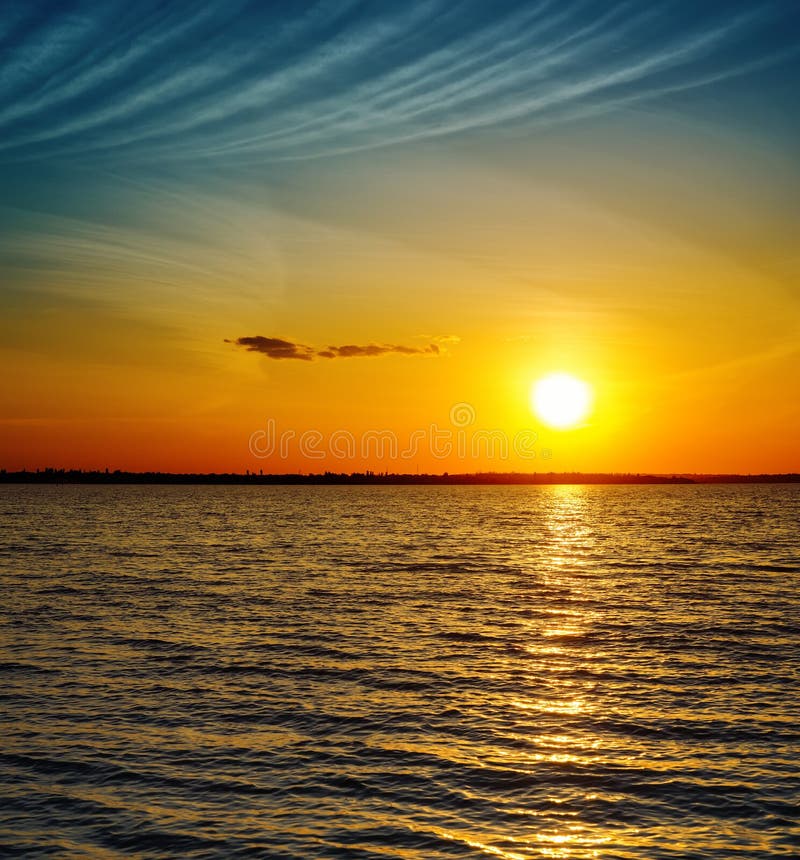 Sunset over dark water stock image. Image of gold, horizon - 32309295