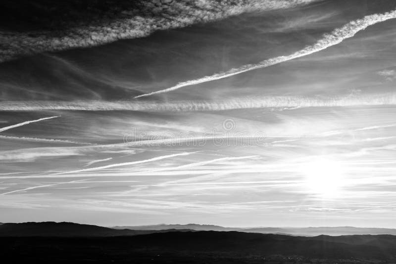 Sunset Over Distant Mountains, with Sky Full of White Clouds and Vapor ...
